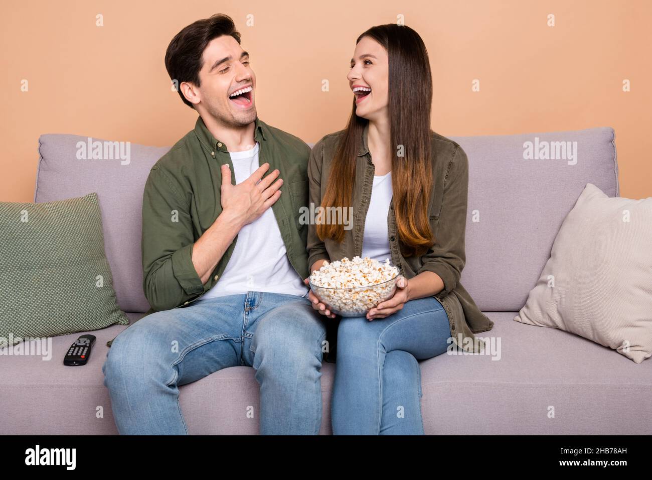 Photo of guy lady buddies sit comfy couch hold pop corn food bowl laugh ...