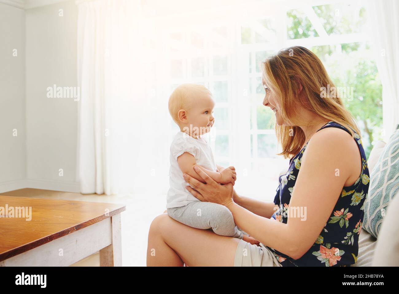 The sound of mom's voice captures her attention Stock Photo - Alamy