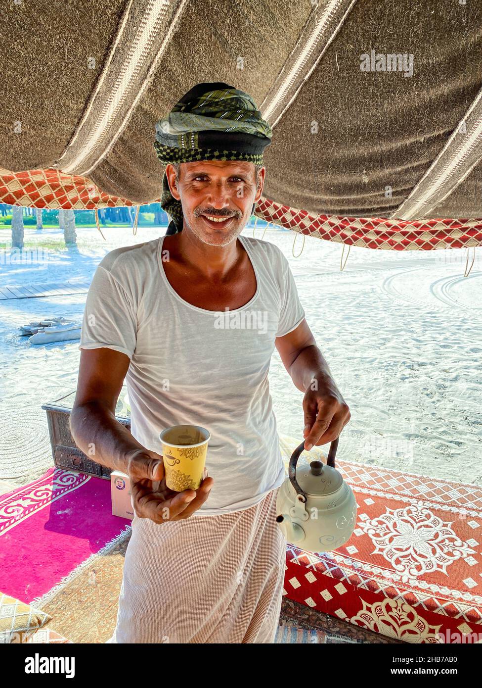 ABU DHABI, UNITED ARAB EMIRATES - Sep 24, 2021: An Emirati Man pouring ...