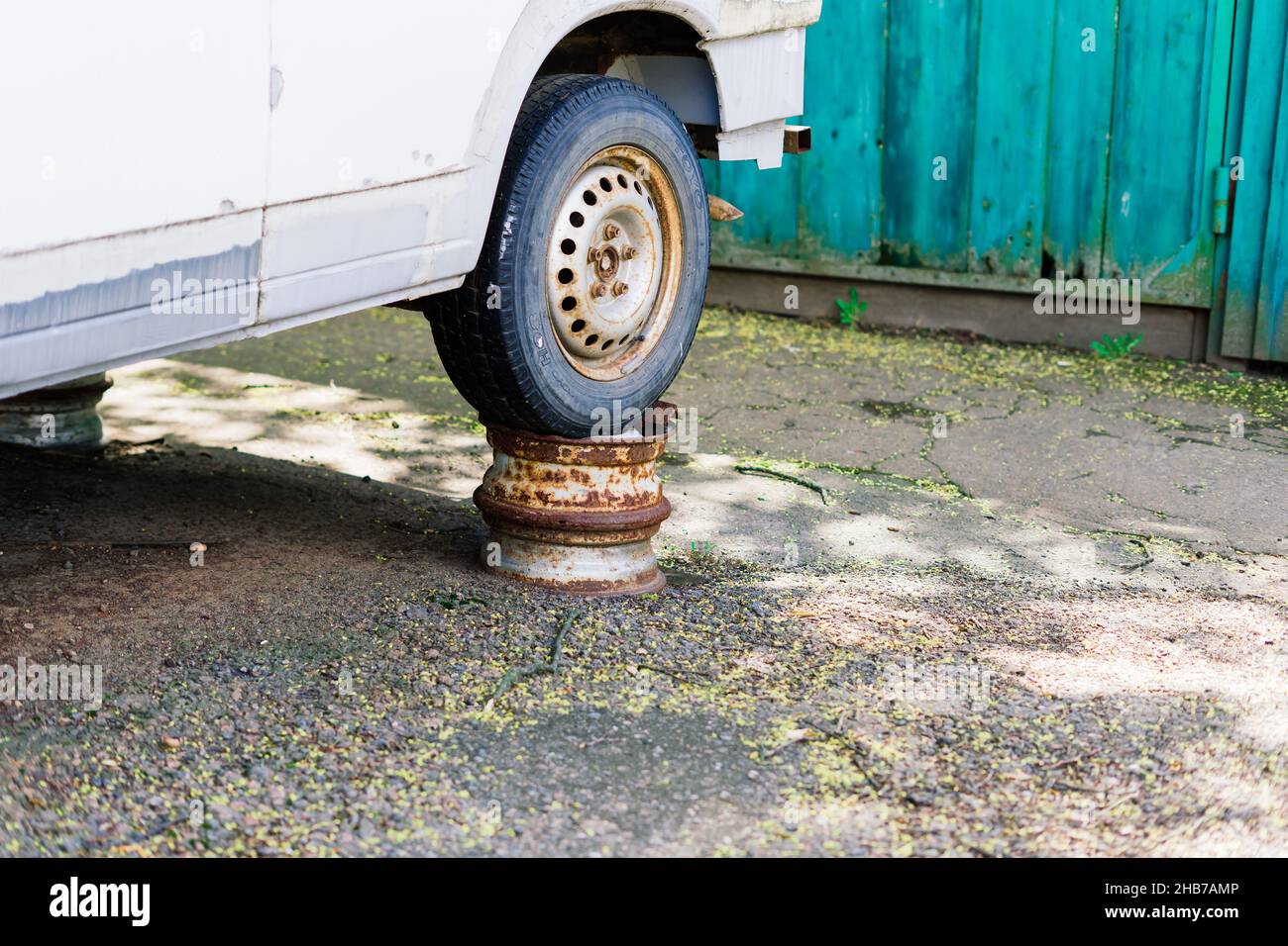 Old rusty car wheel. Cracked tires and a rusted hubcaps Stock Photo - Alamy