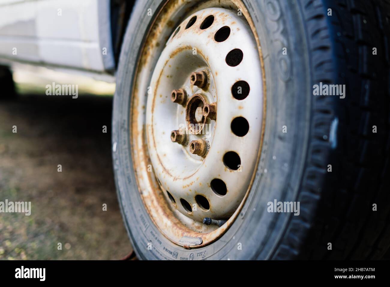 Old rusty car wheel. Cracked tires and a rusted hubcaps Stock Photo - Alamy