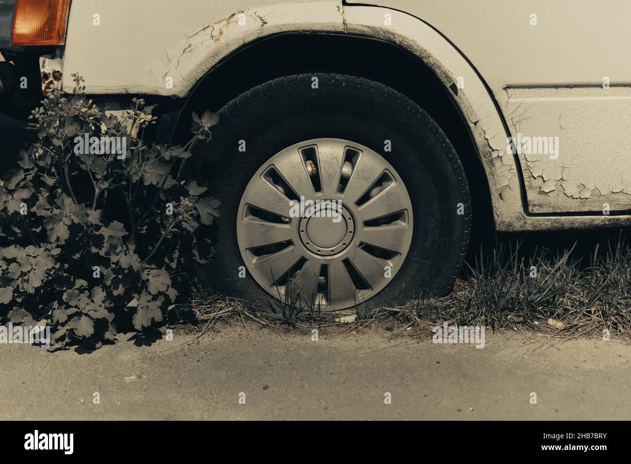 Old rusty car wheel. Cracked tires and a rusted hubcaps Stock Photo - Alamy