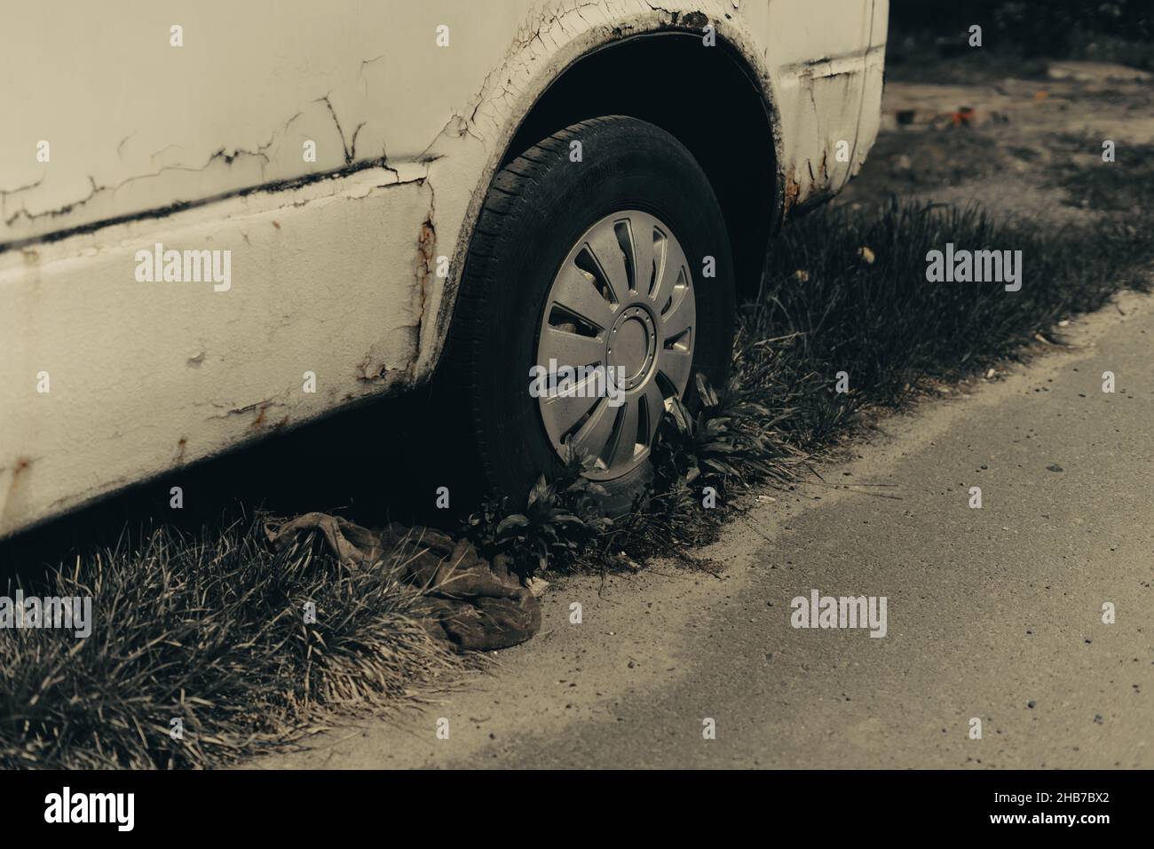 Old rusty car wheel. Cracked tires and a rusted hubcaps Stock Photo - Alamy