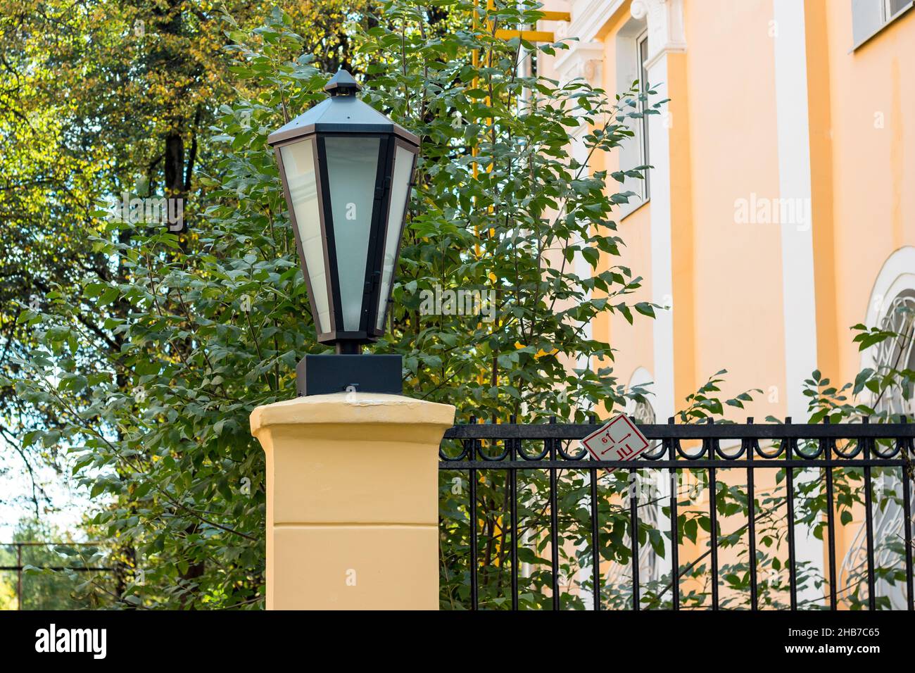 Street lamp in a retro style on the gate of a residential apartment ...
