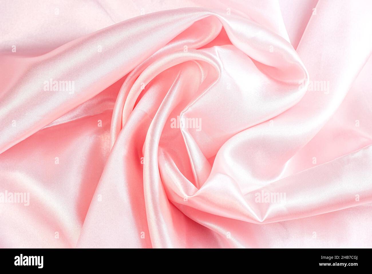 Light pastel pink color silk wavy textile pattern as a smooth textured ...