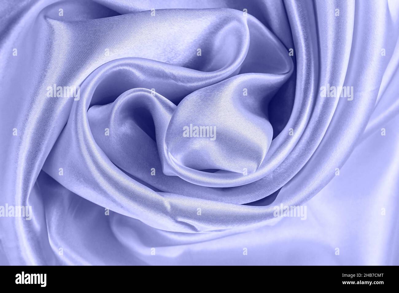 Light purple Very Peri color silk wavy textile pattern as a smooth textured background. Blue ...