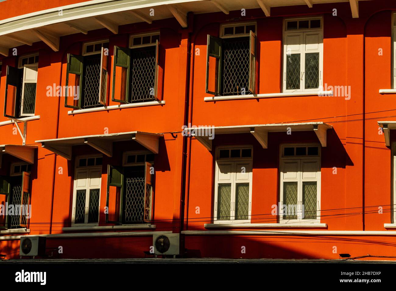 Exterior facade of a small red residential building Stock Photo - Alamy