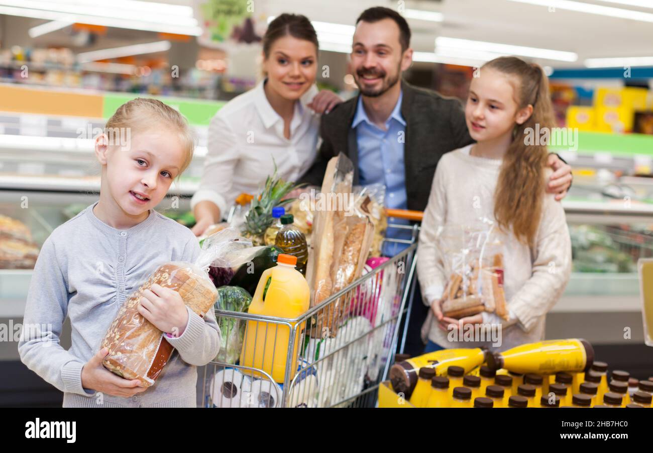 Positive kids and parents with purchases Stock Photo - Alamy