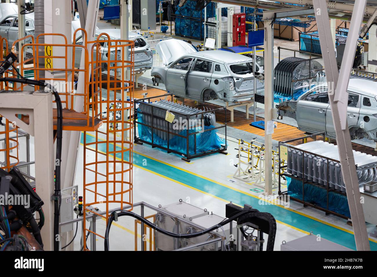 Car bodies are on assembly line. Factory for production of cars. Modern ...