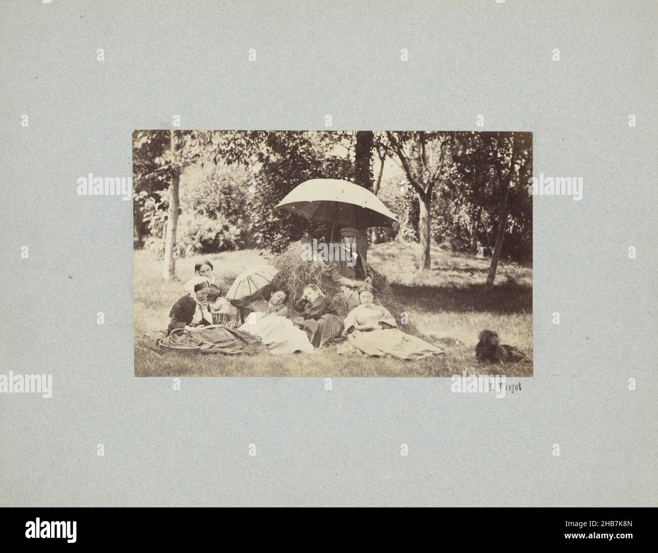 Unknown family resting under umbrellas hi-res stock photography and ...