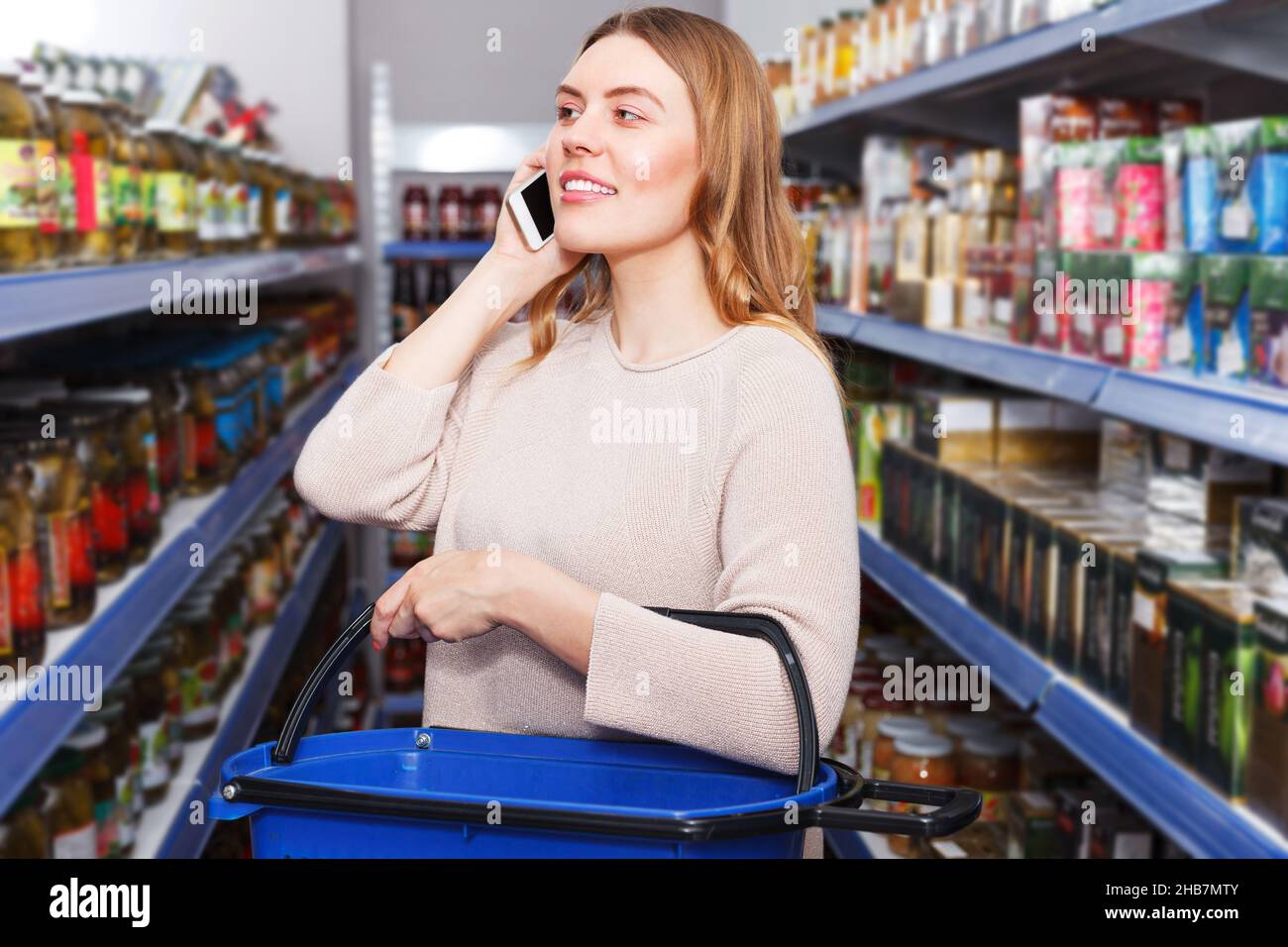 Female talking by phone in grocery Stock Photo - Alamy