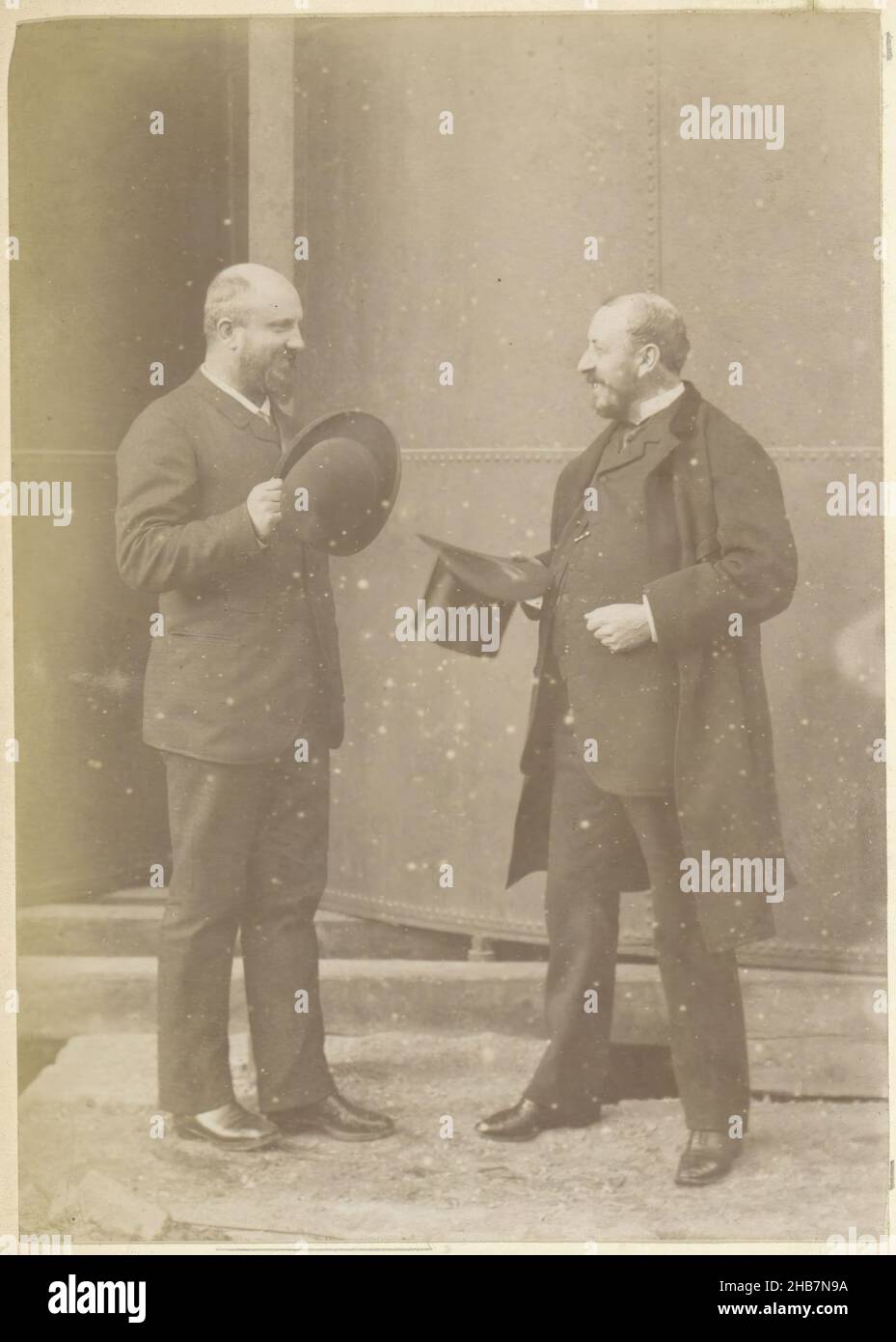 Portrait of two French men with hats, standing in front of a metal ...