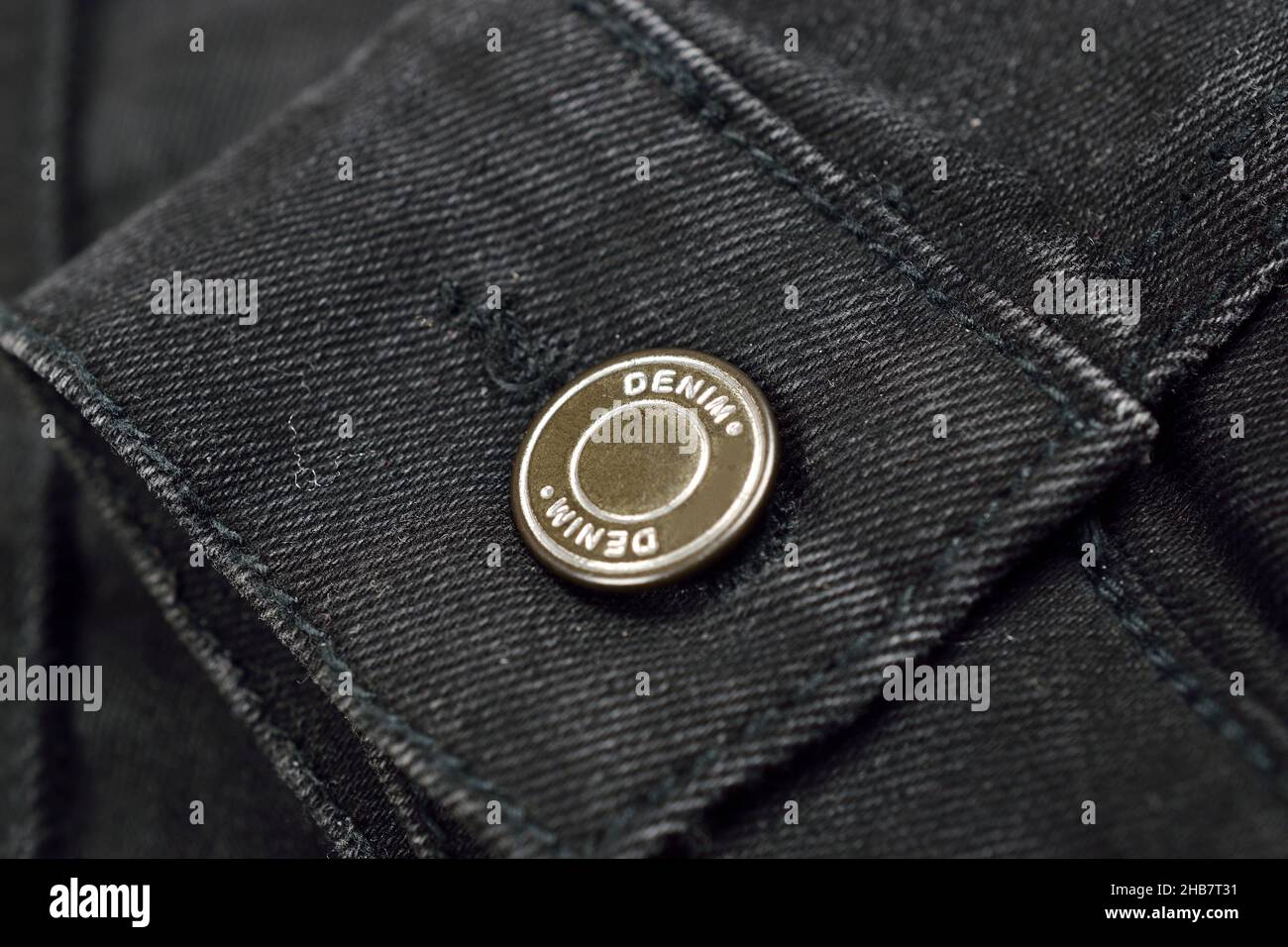 Silver Button on Black Denim Jacket Stock Photo - Alamy