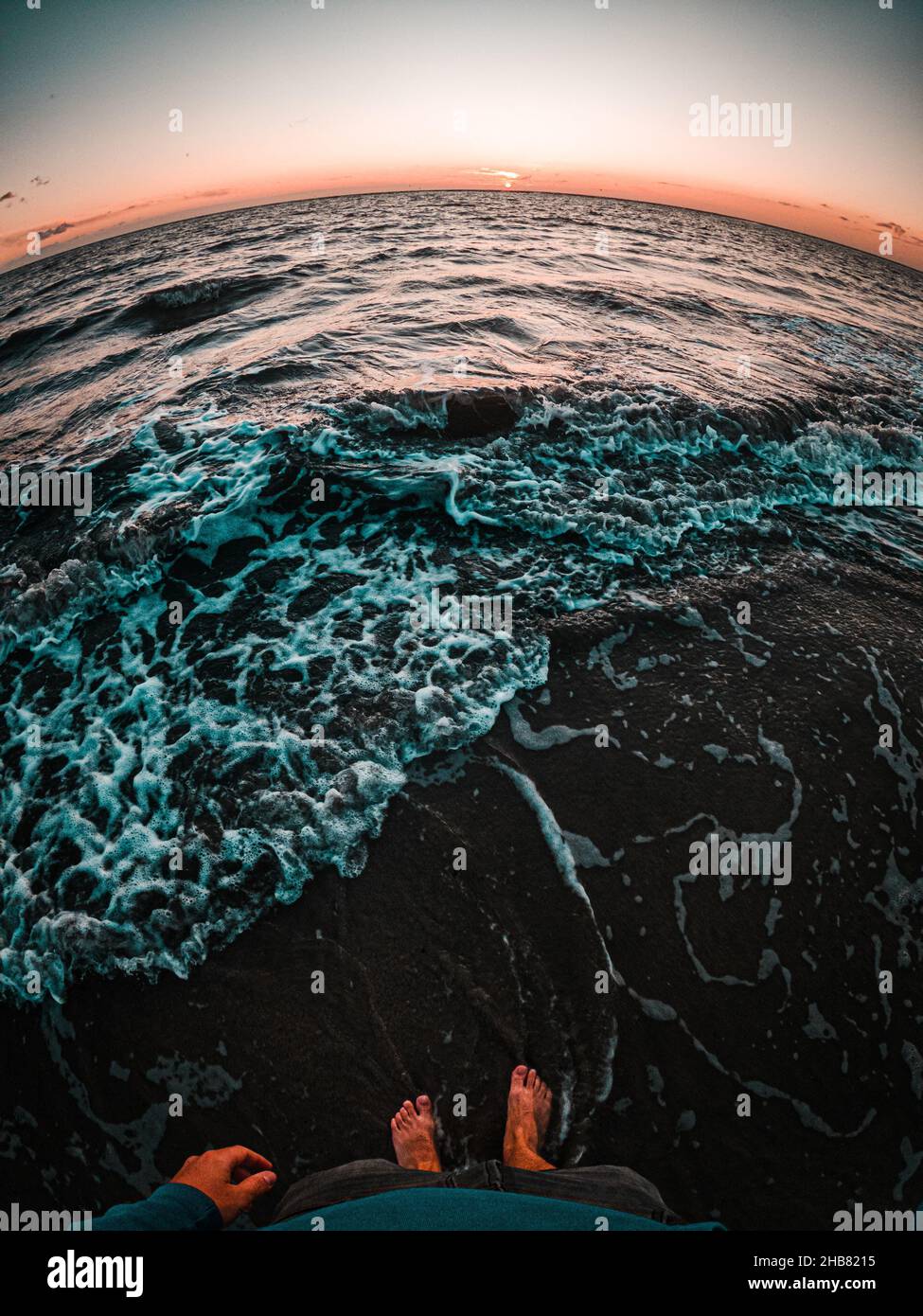 High angle shot of the feet of a person standing on the cliff over the ...