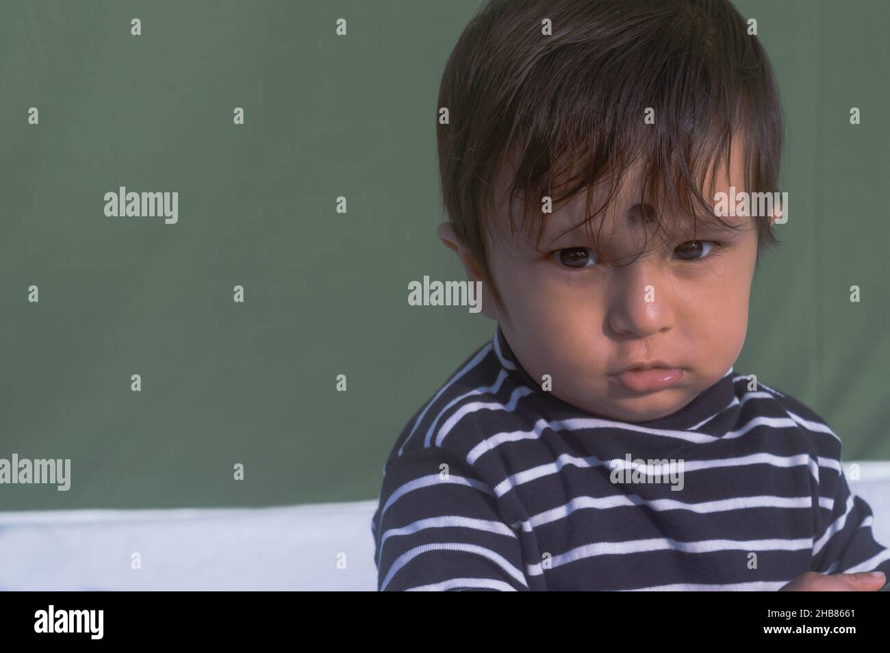Close up portrait of one cute Sweet little baby looking shock and sad ...