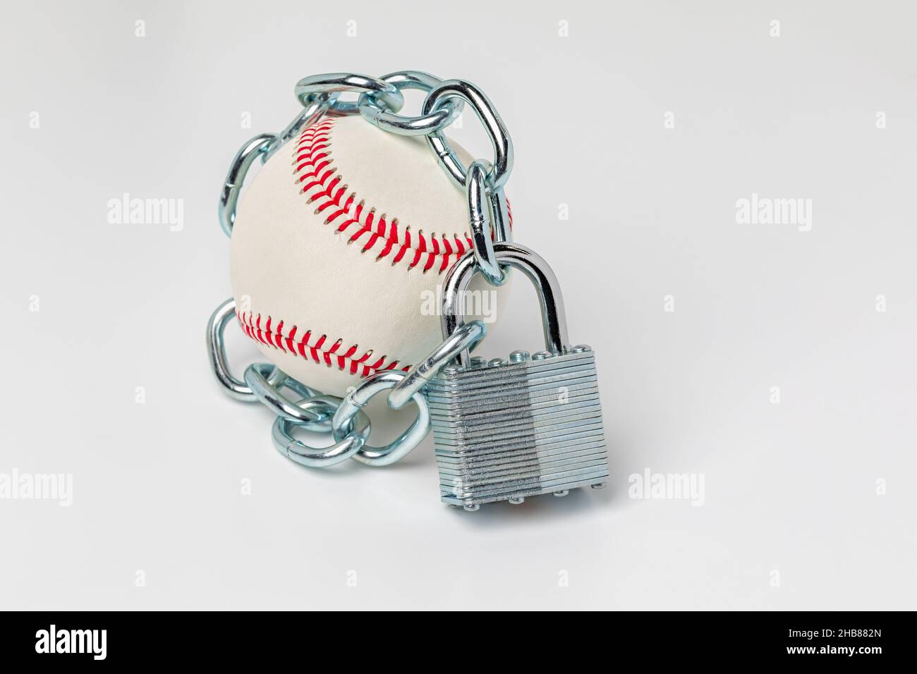 Baseball with chain and lock. Baseball strike, lockout and labor ...