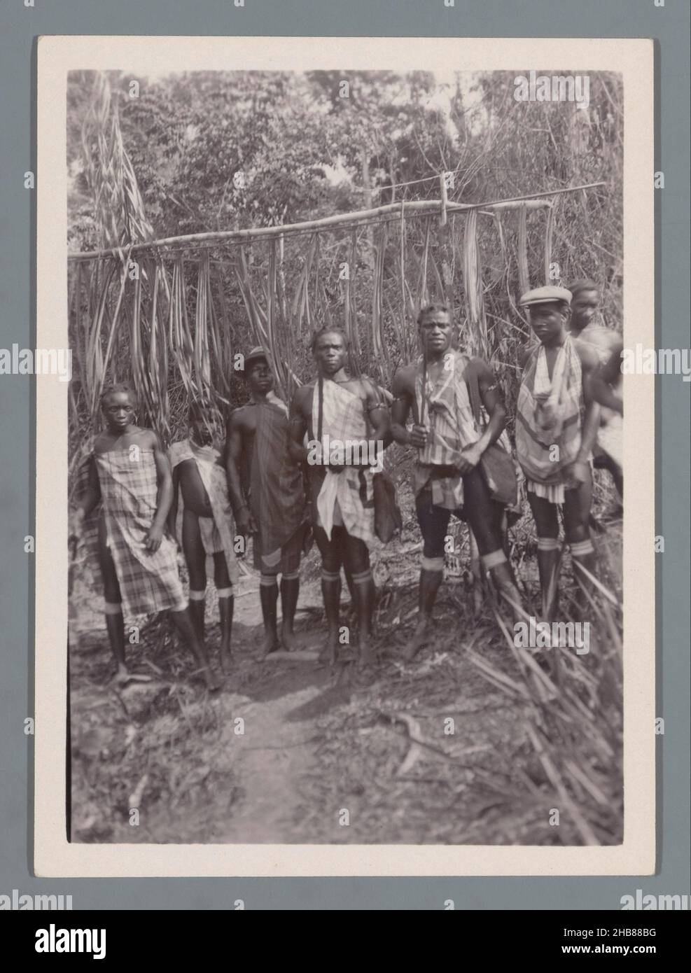 Seven Maroon men in front of the entrance of a Maroon village ...