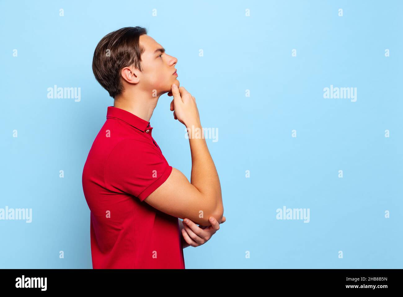 Profile view of young handsome man, student thinking about future ...