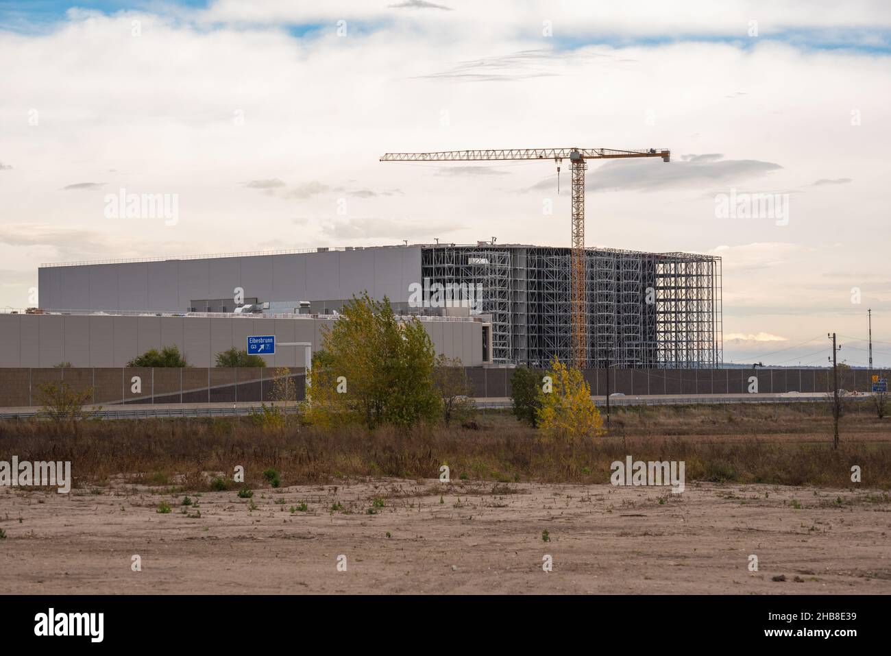 Warehouse under construction without external wall. Metal shelves of a ...