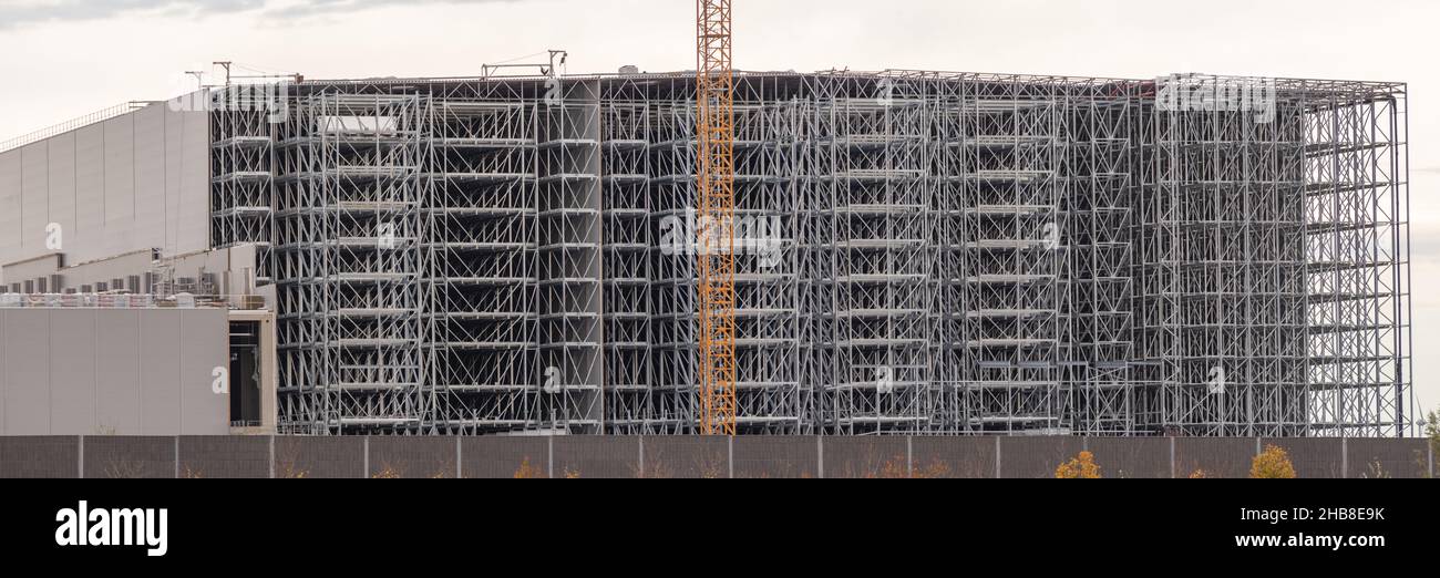 Warehouse under construction without external wall. Metal shelves of a ...