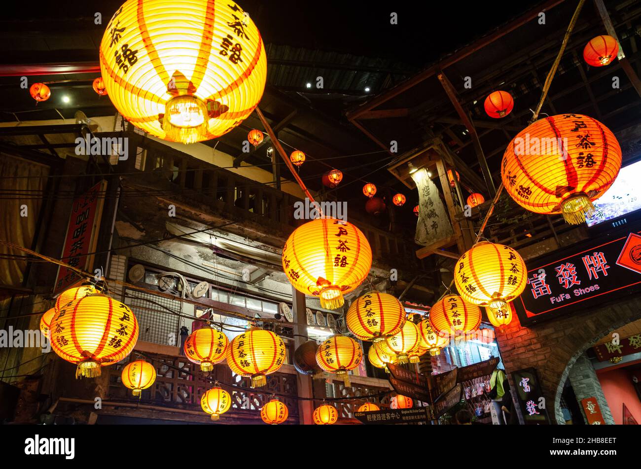 Late night view of Jiufen village old street illuminated with lanterns ...