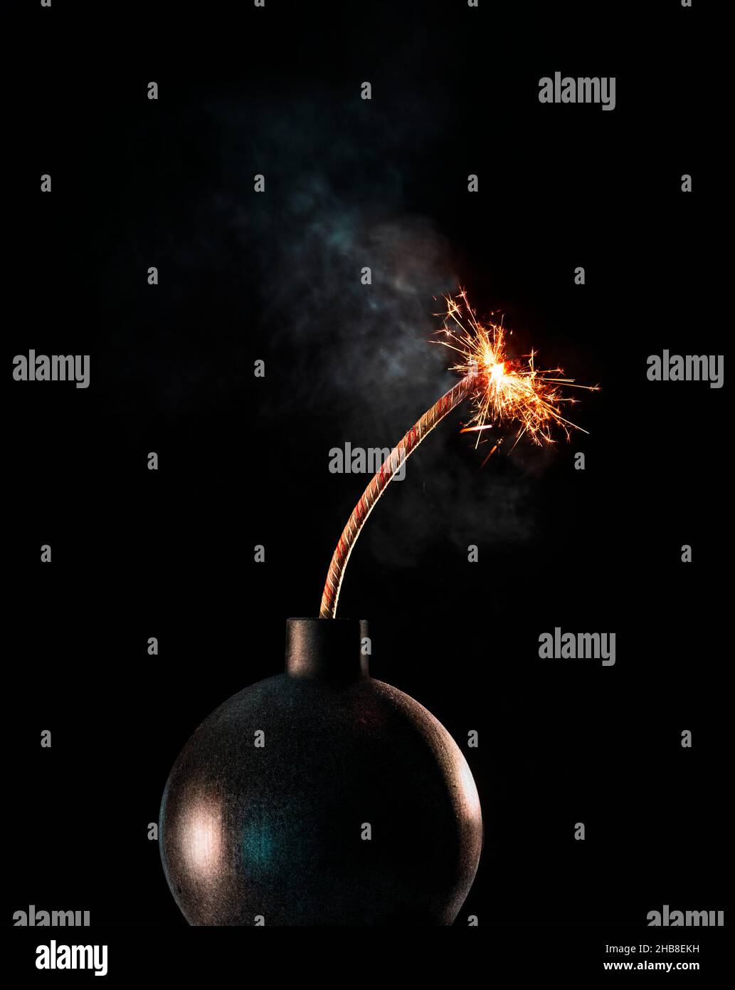 Black bomb with lit fuse against black background Stock Photo - Alamy