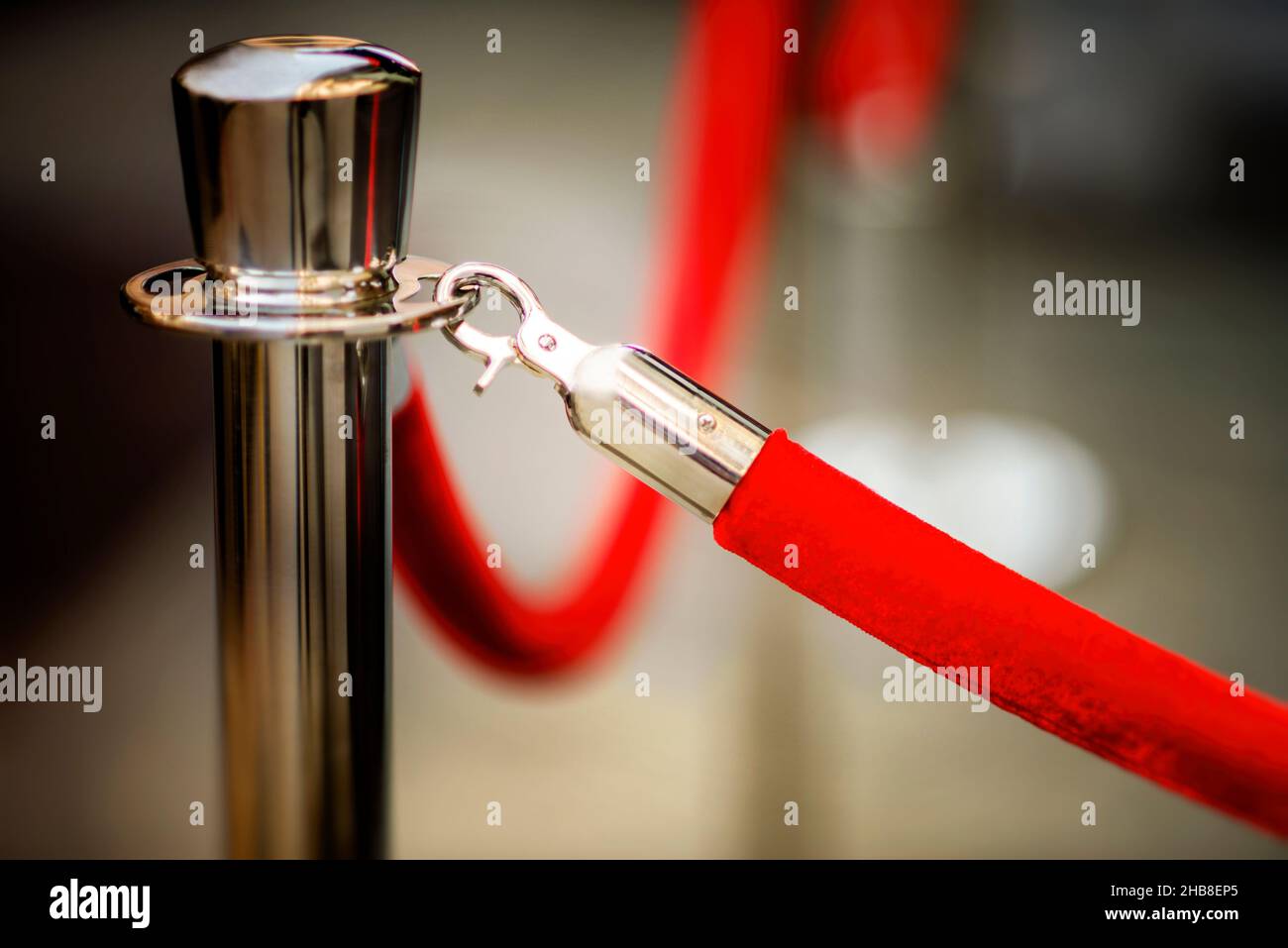 Close-up of red rope and stanchion Stock Photo - Alamy
