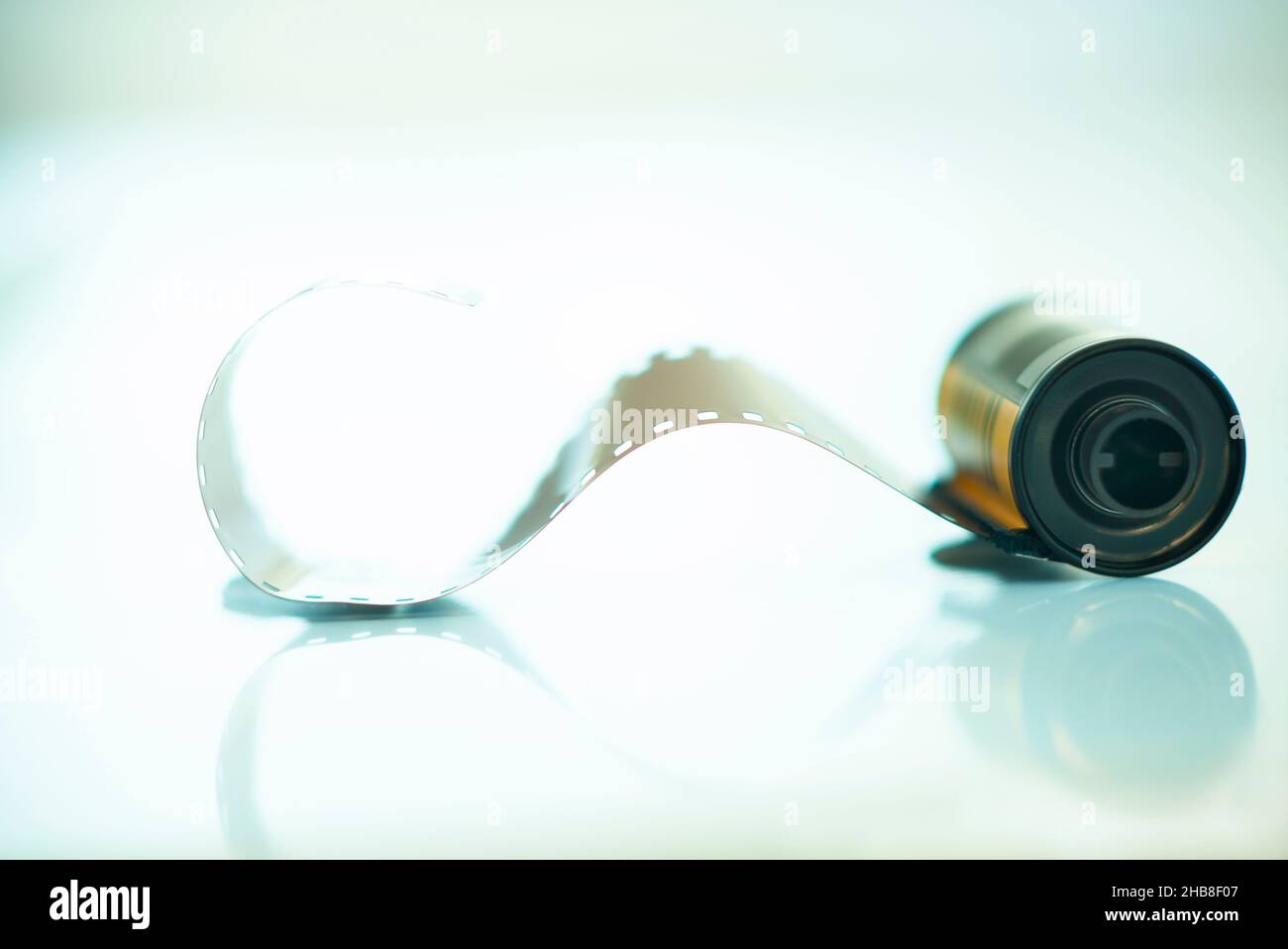 Studio shot of spool of 35mm film with some film pulled out Stock Photo ...