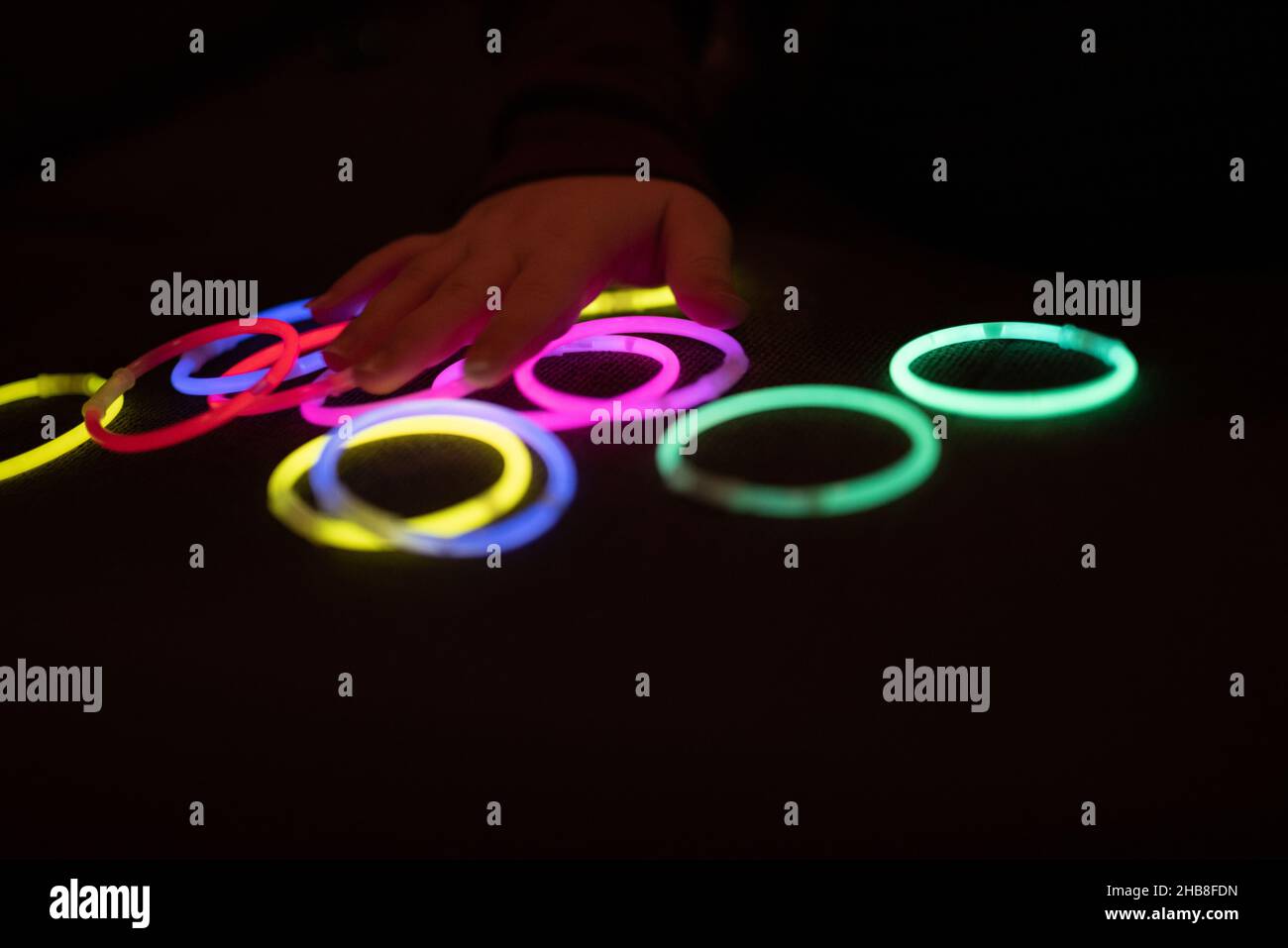 Colorful led rings glowing in the black background. Luminous rings in ...