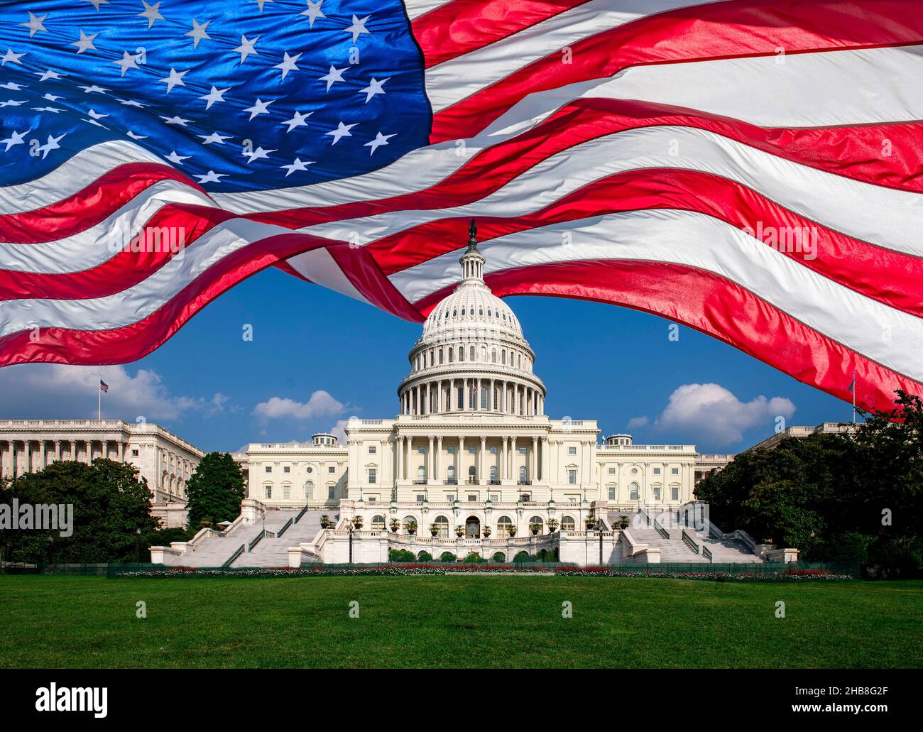American flag waving over Capital Building Stock Photo - Alamy
