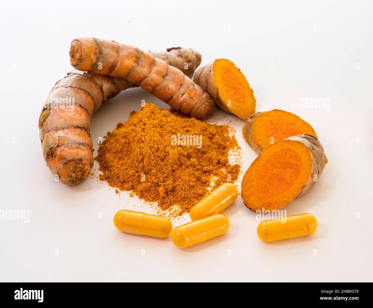 Turmeric powder, root and capsules on white background Stock Photo - Alamy