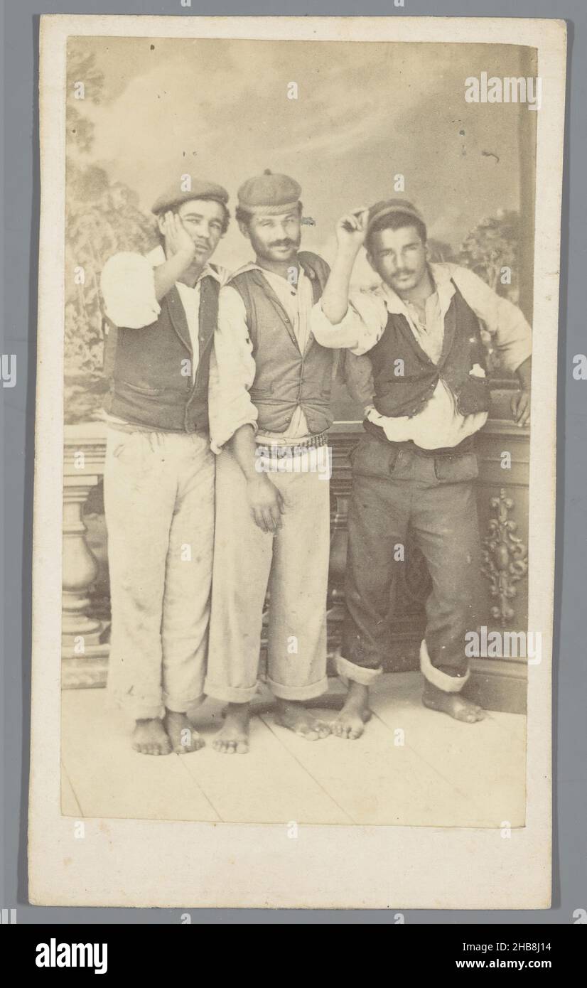 Portrait of three unknown men wearing caps and barefoot, Three young ...