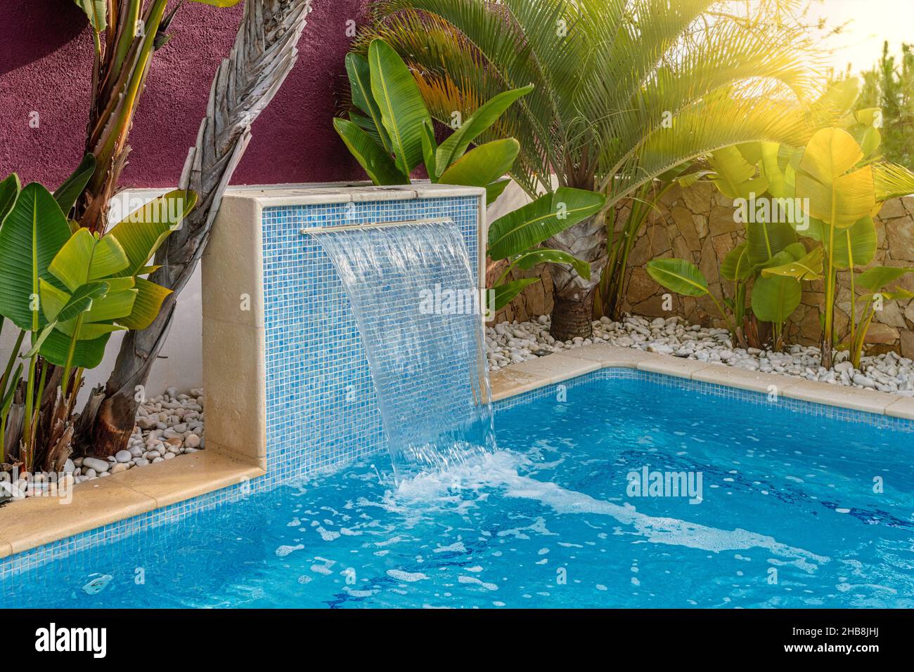 Close-up of a fountain waterfall in a luxury pool near the hotel with ...