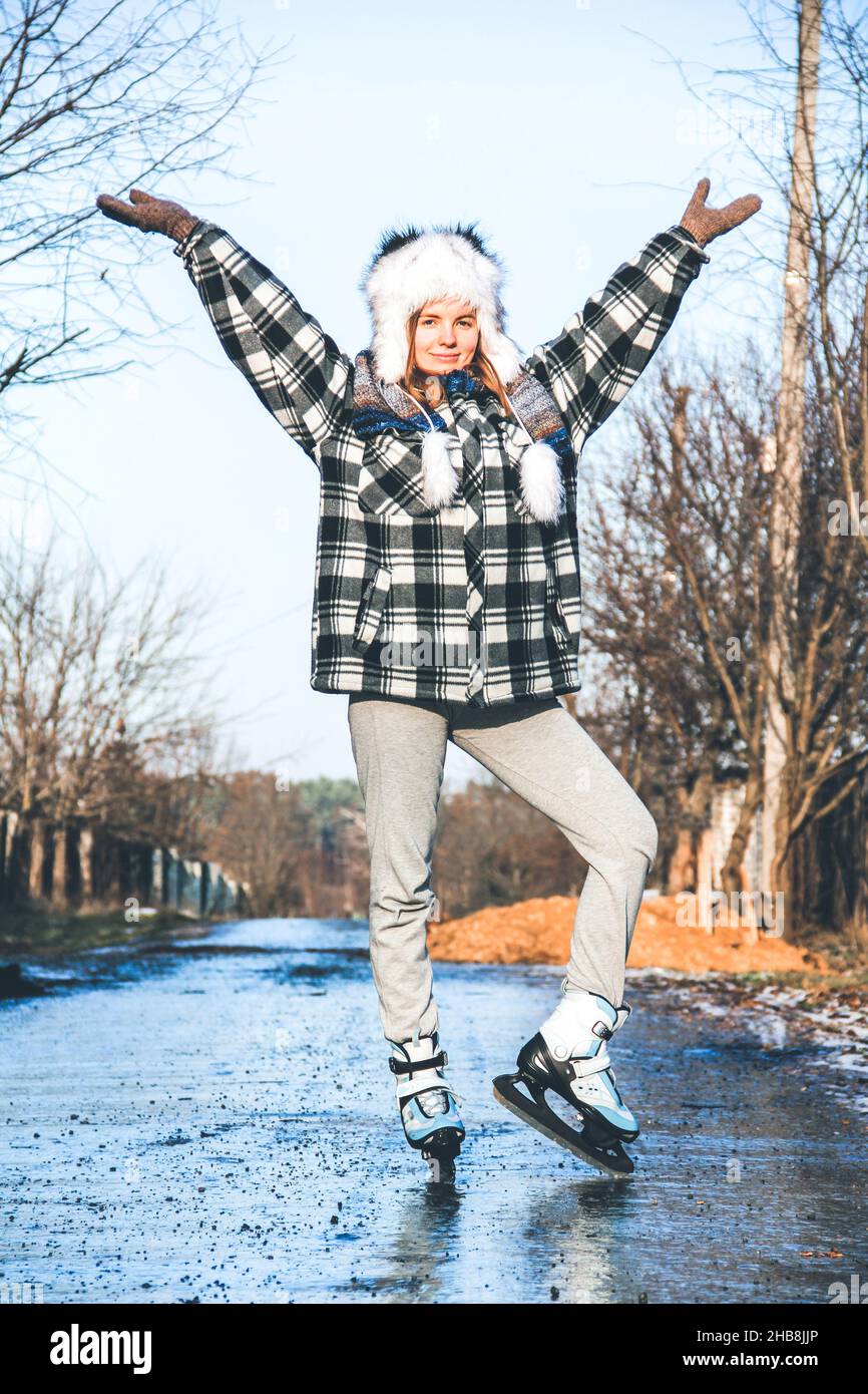 Ice skating girl. Figure skating. Winter leisure. Winter asphalt icing ...