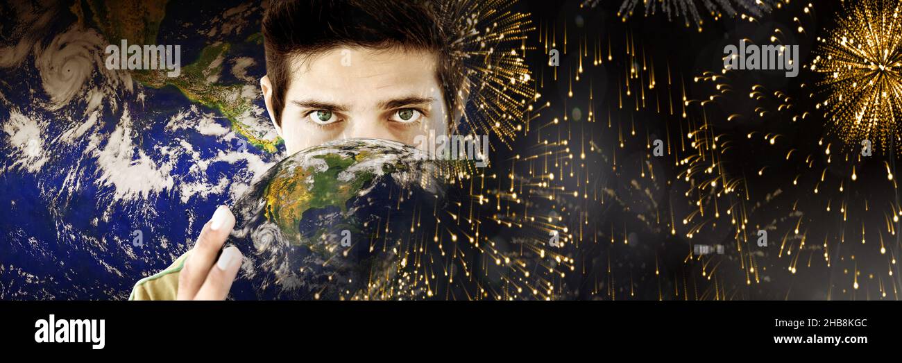 Composite image of man holding a globe and fireworks explosions against ...