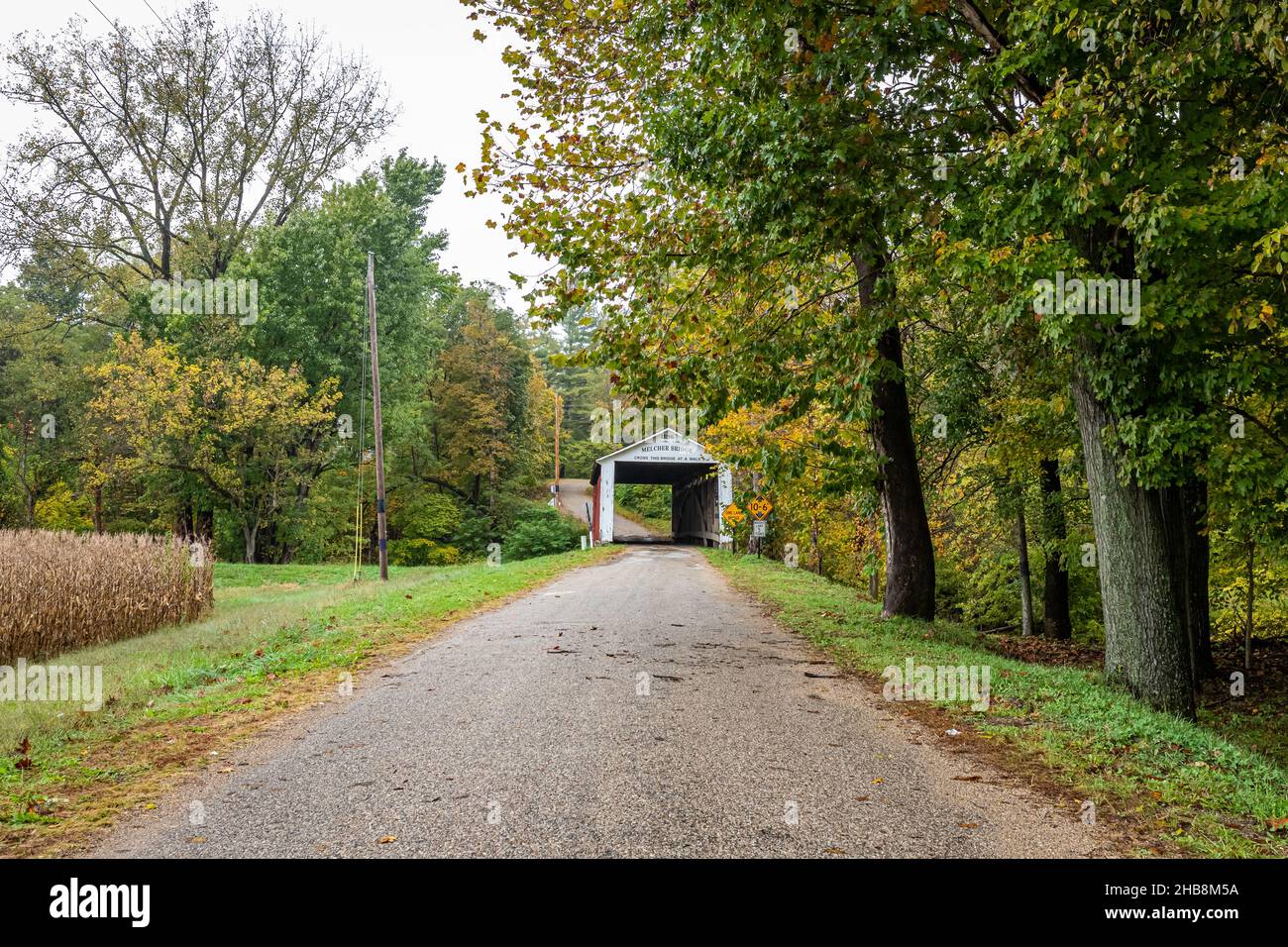 The Melcher Covered Bridge crosses Big Raccoon Creek during Autumn leaf ...