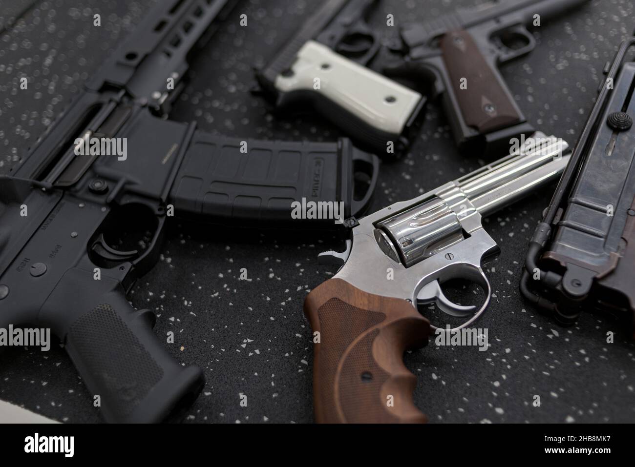 Firearms on display. Still life of guns over table Stock Photo - Alamy