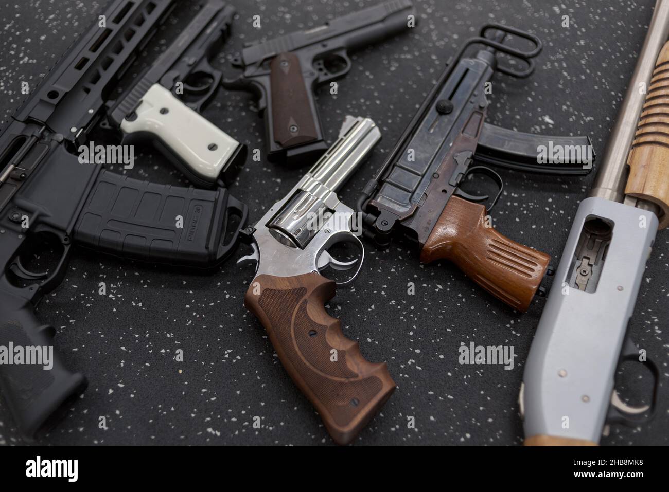 Firearms on display. Still life of guns over table Stock Photo - Alamy