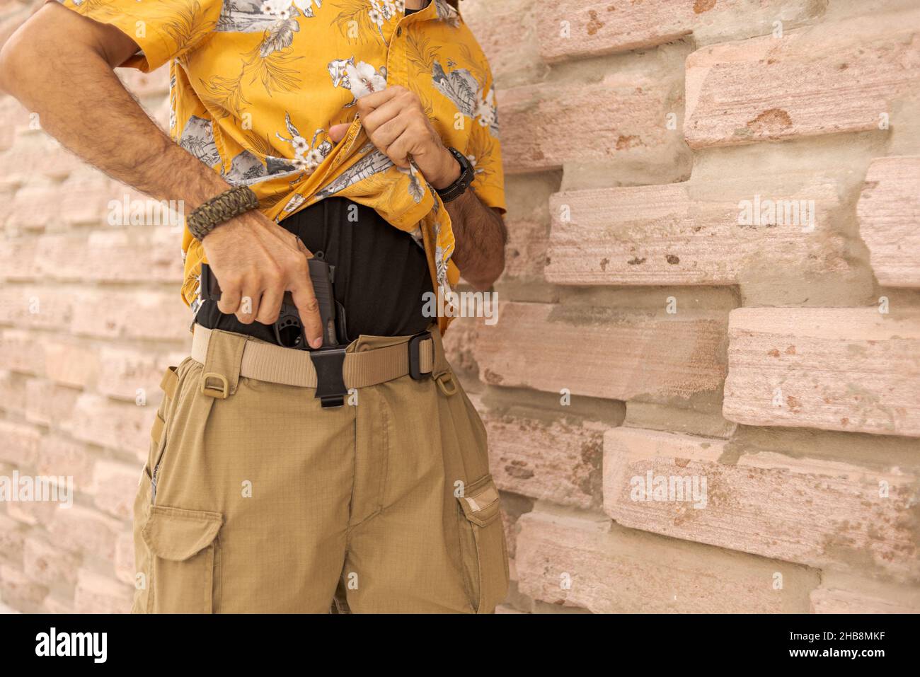 Man handling firearm revolver pistol Stock Photo - Alamy