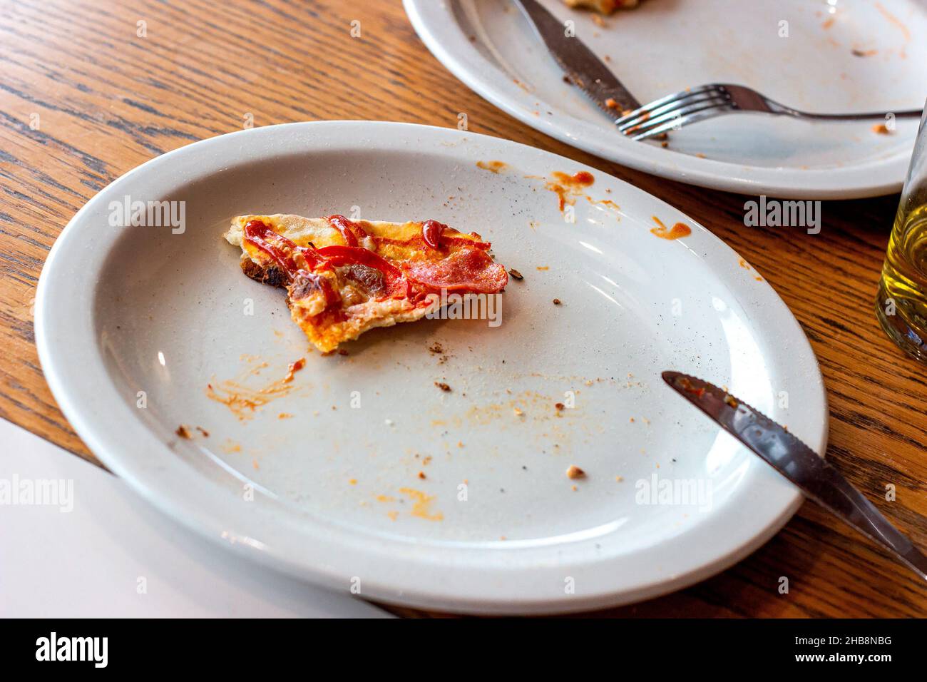 Dirty messy plates after pizza eating with unclean used utensils in the ...