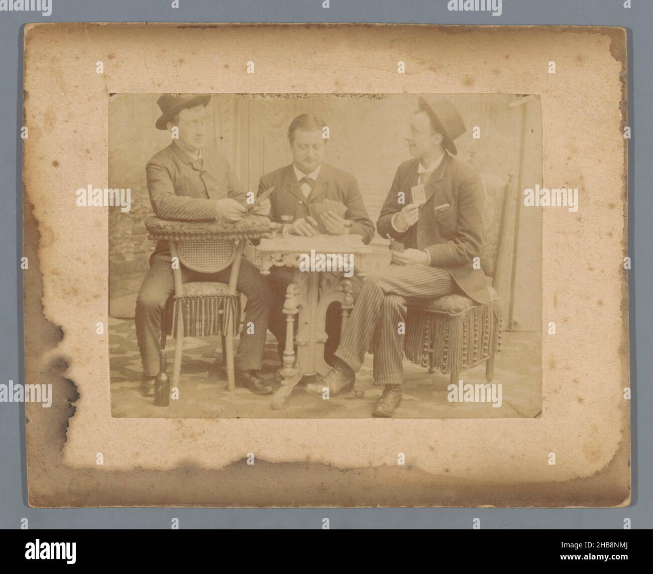 Three men playing cards around a table in an interior, anonymous, c ...