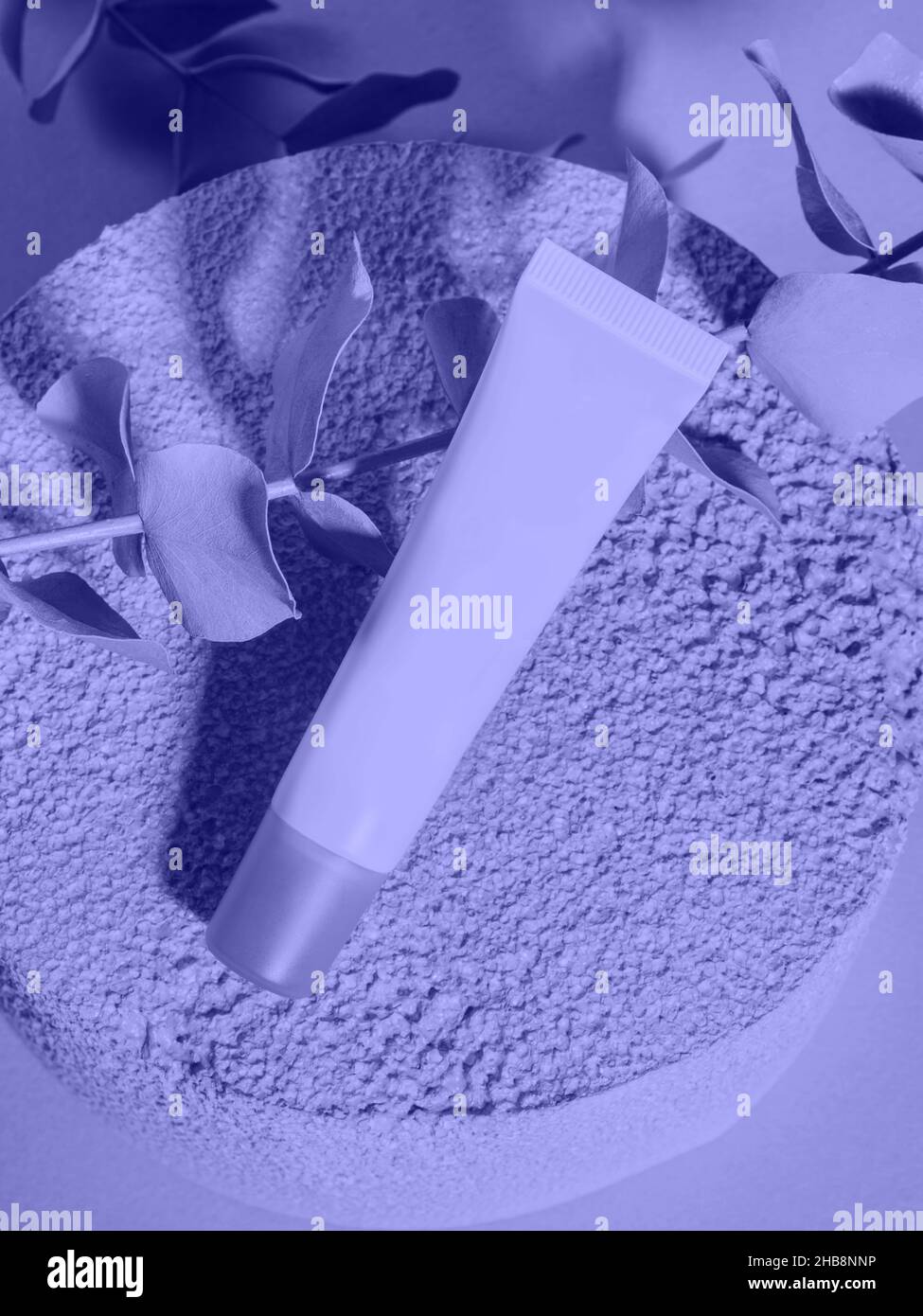 Generic cream tube on purple textured podium on monochrome background ...