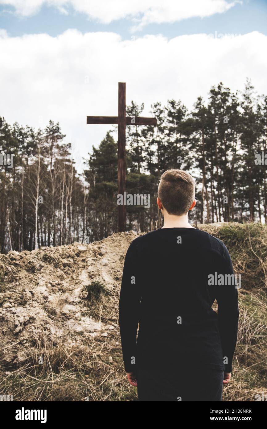 The man looks at the cross. Man believes in God. Hope in God Stock ...