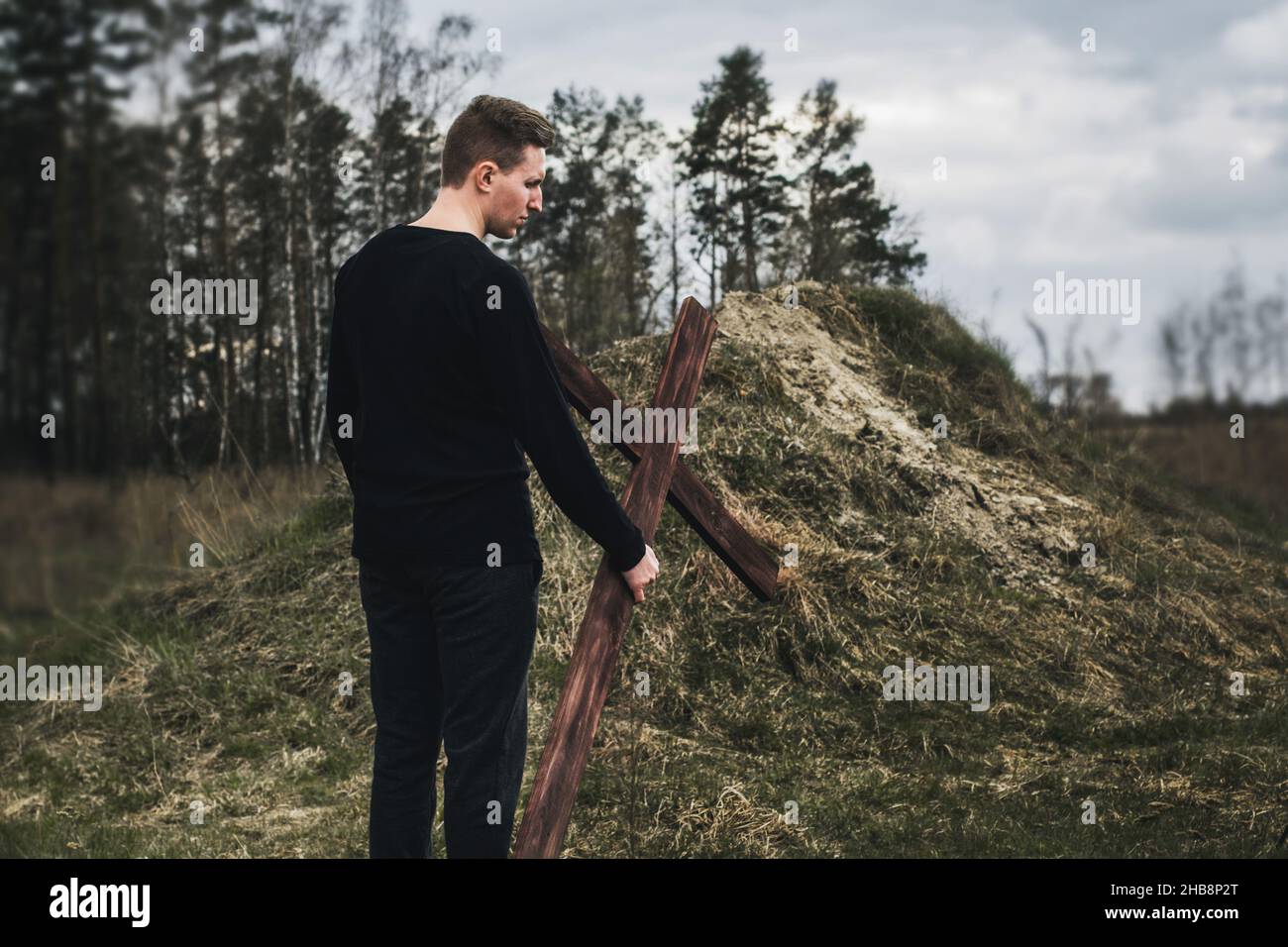 The man carries the cross. Сarry the cross. Man believes in God. Hope ...