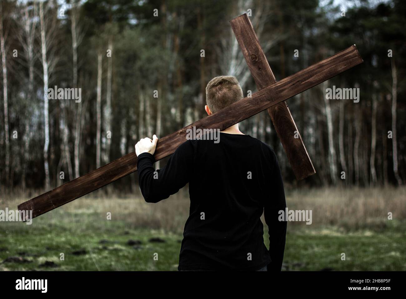 The man carries the cross. Сarry the cross. Man believes in God. Hope ...