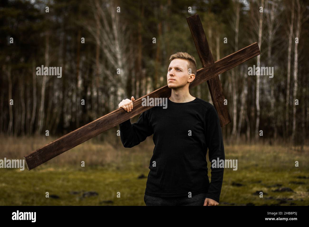 The man carries the cross. Сarry the cross. Man believes in God. Hope ...