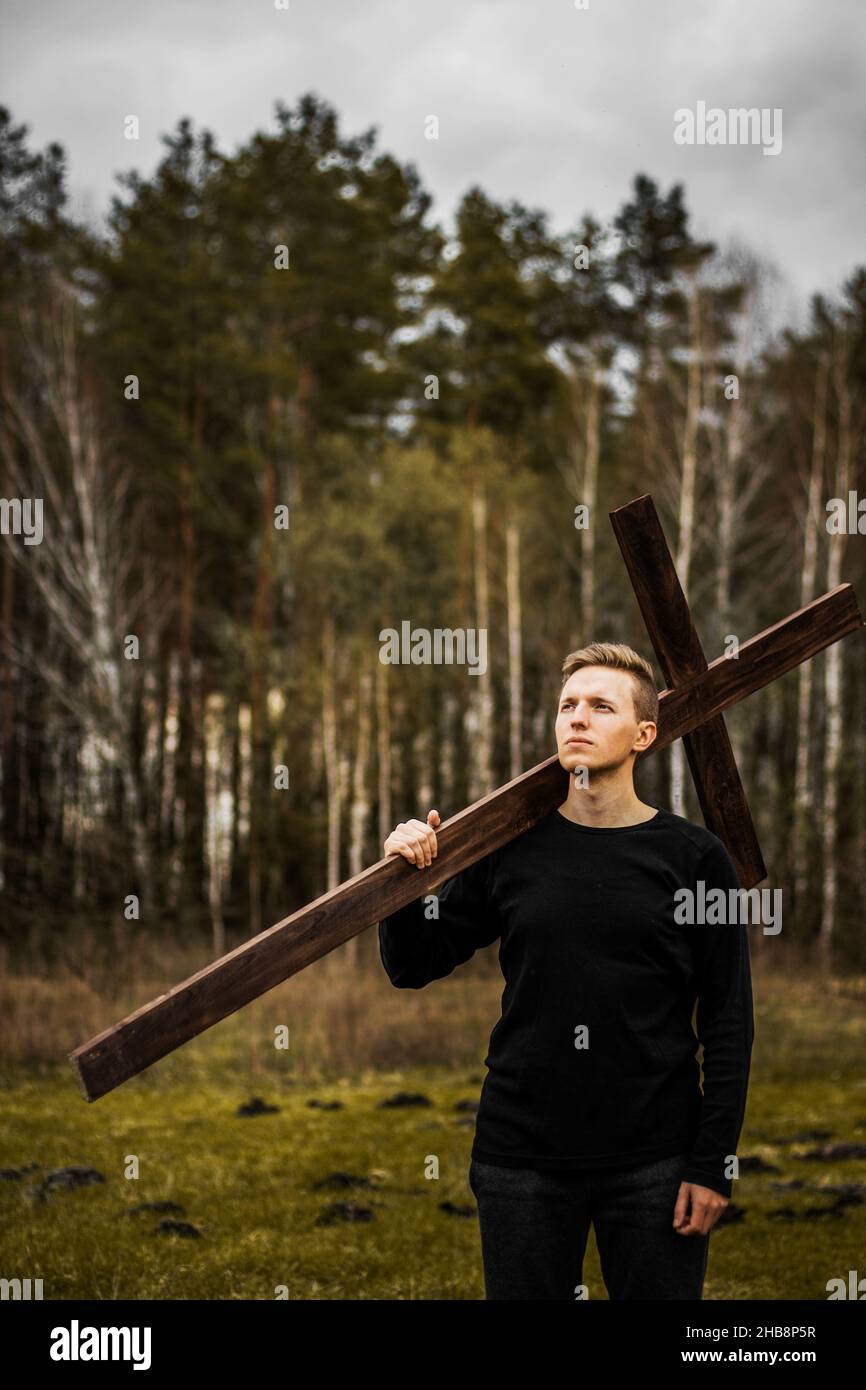The man carries the cross. Сarry the cross. Man believes in God. Hope ...