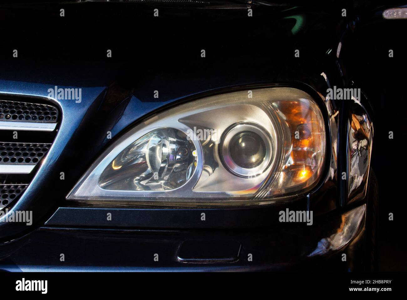 Car headlights. Luxury Headlights. Car details. Part of a blue car ...