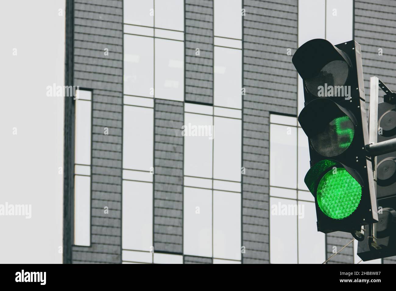 Traffic light on the background of the building. Traffic light green ...