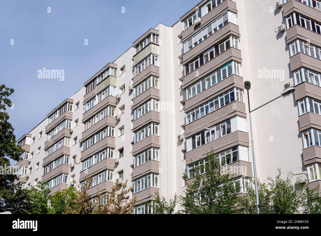 Renovated typical old block of flats towards clear blue sky in ...